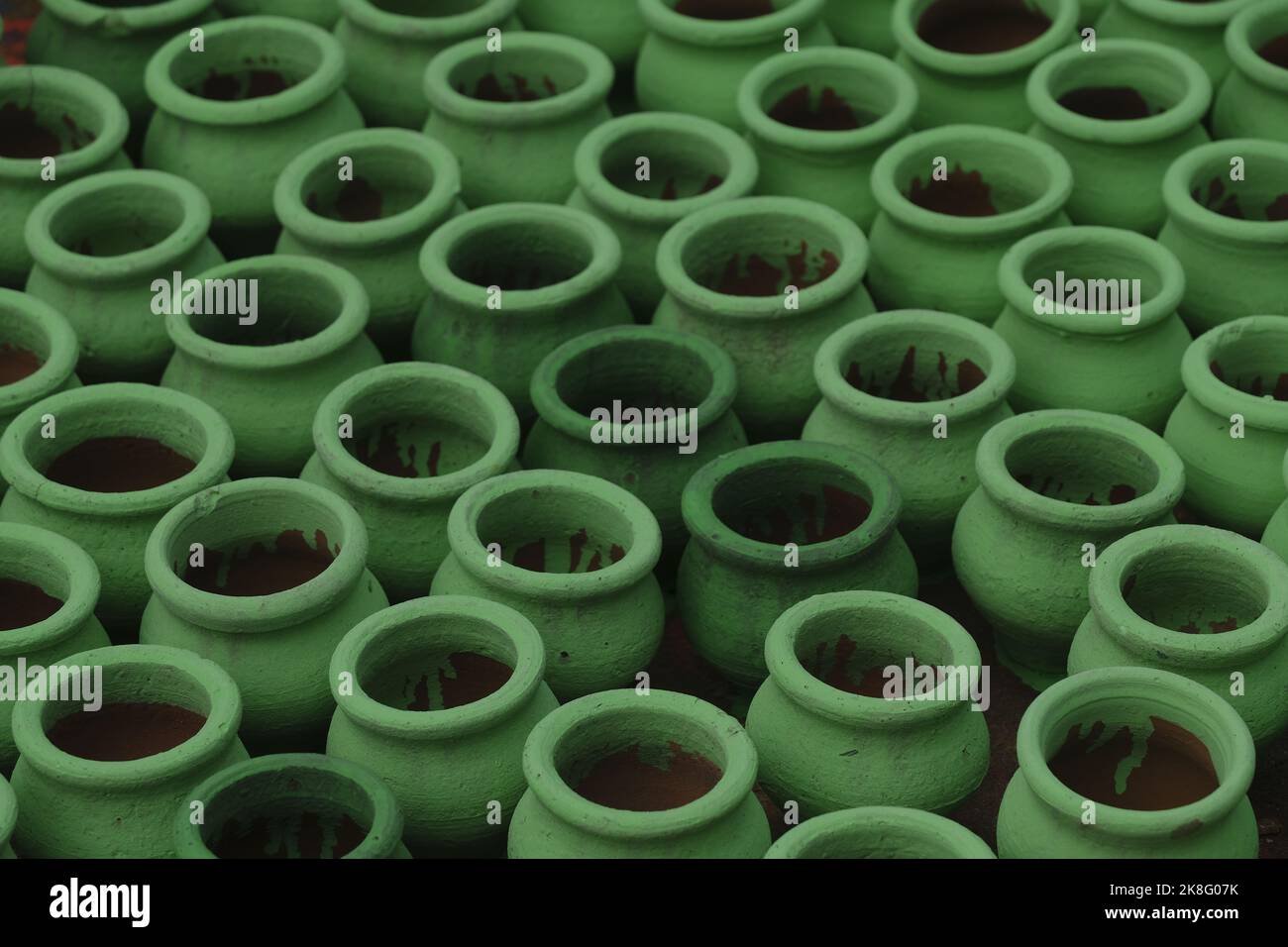 Artisan painting earthen pots, A background of colorful pots used for ...