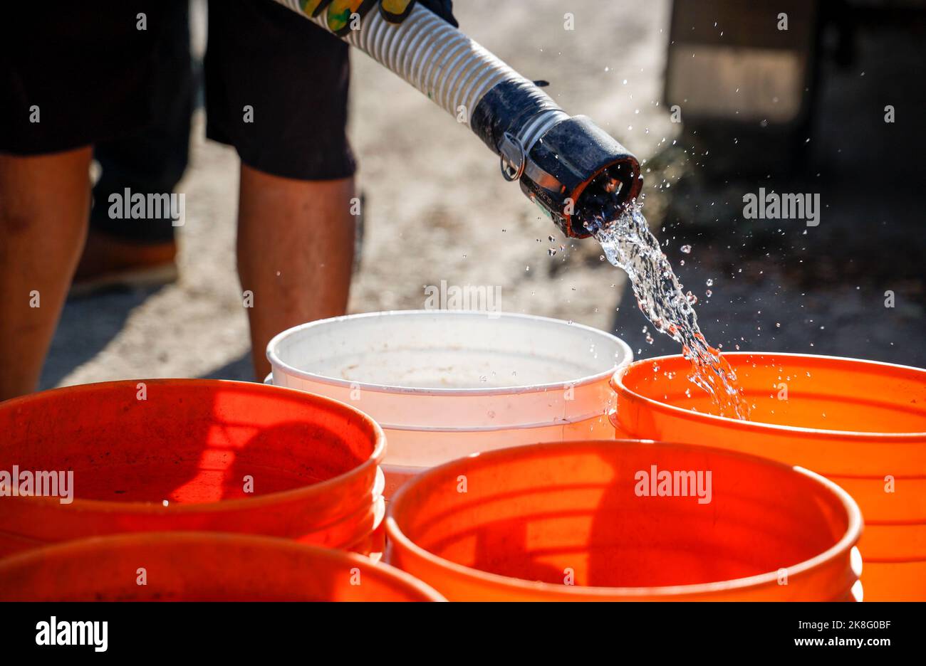 A Blood Tribe Land Management department employee fills buckets with ...