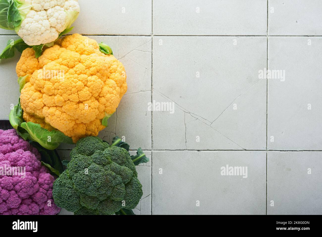 Colorfu cauliflower. Various sort of cauliflower on stone tiles gray ...