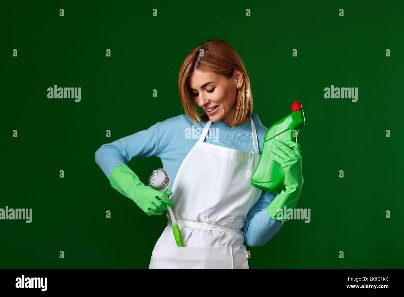 woman in gloves holding brush and bottle of detergent Stock Photo - Alamy