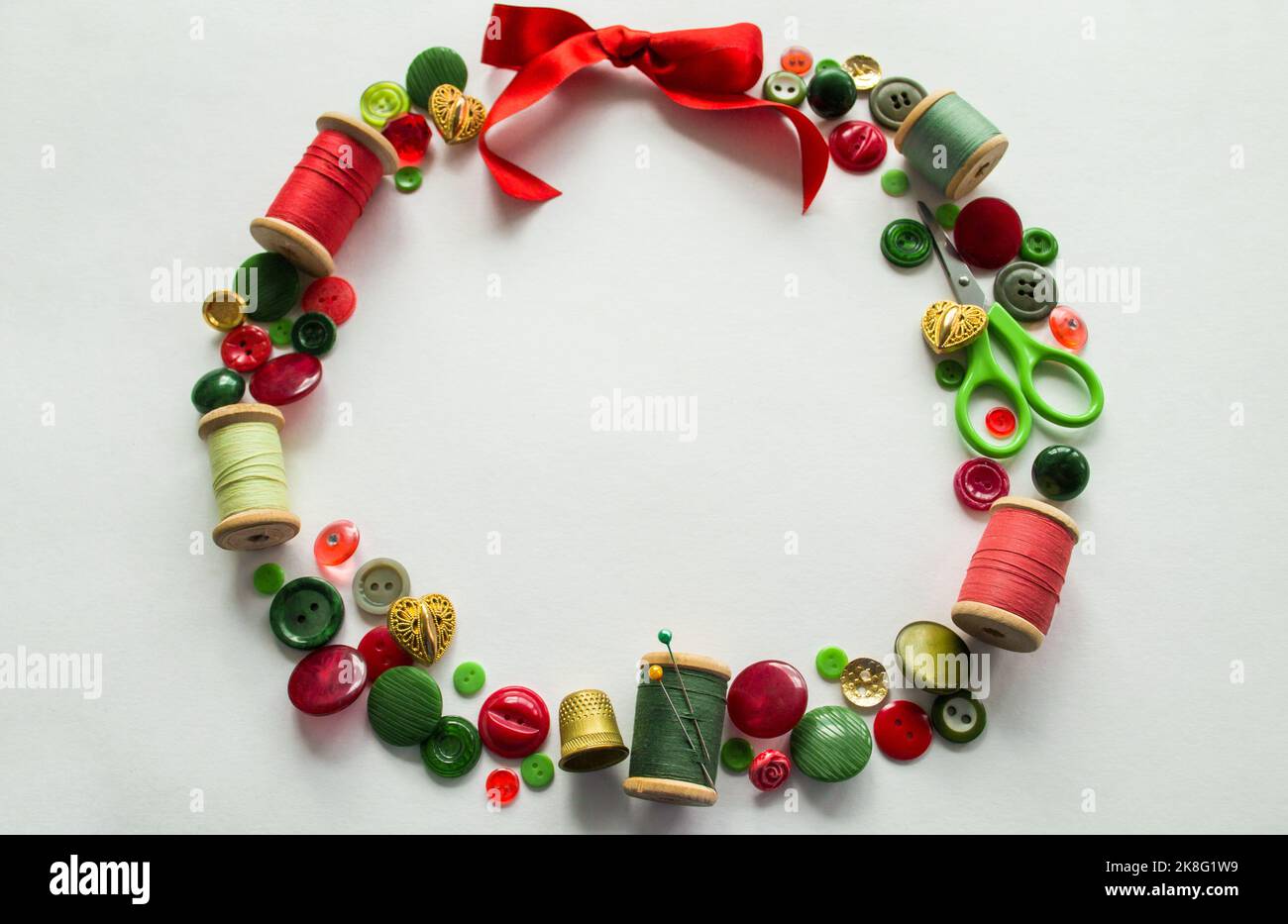 Christmas wreath made of buttons, threads, pins, scissors, thimble red ...