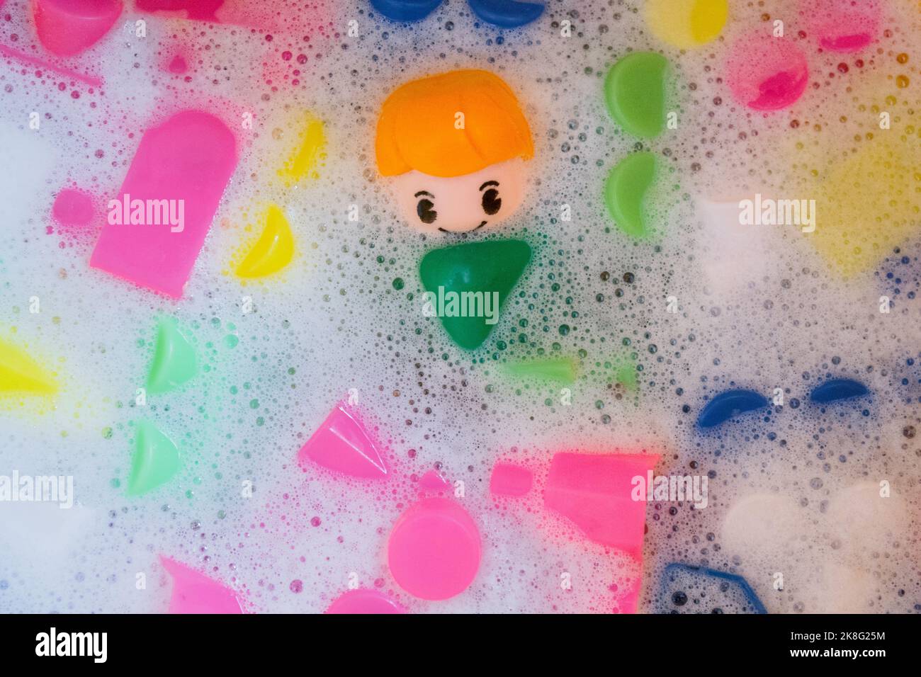 Washing of children toys, plastic building blocks with figurines. A ...