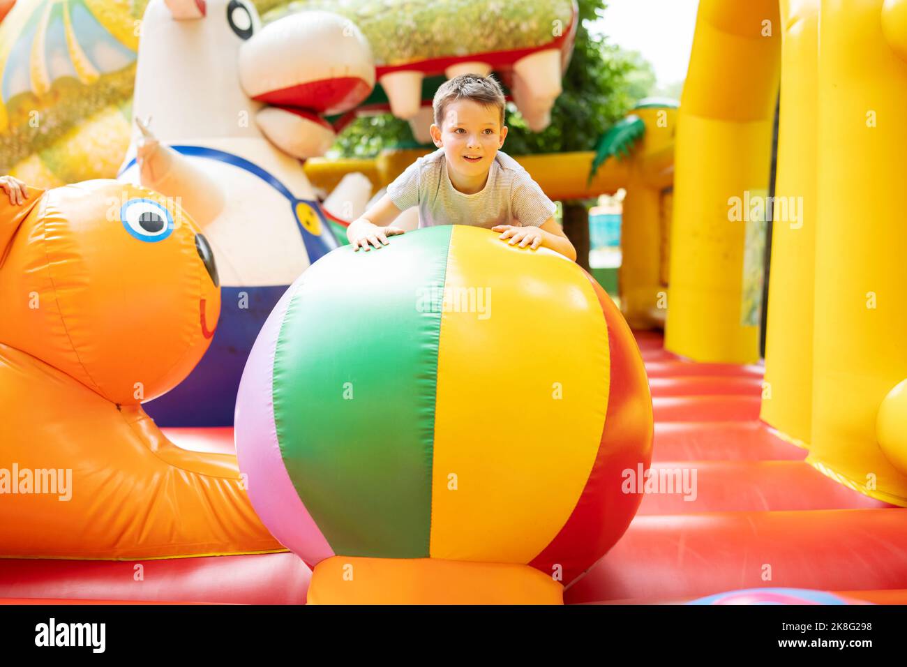 Happy boy having a lots of fun on a colorful inflate castle Stock Photo ...