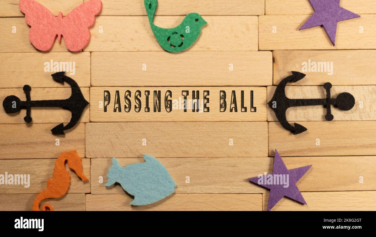 Wooden man holding frame. Passing the ball inscription. Background is ...