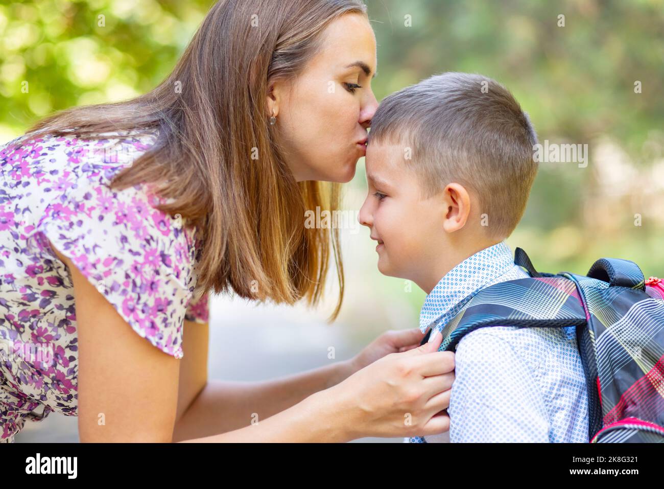 Back to school. Mother saying goodbye to her son as he leave for School ...