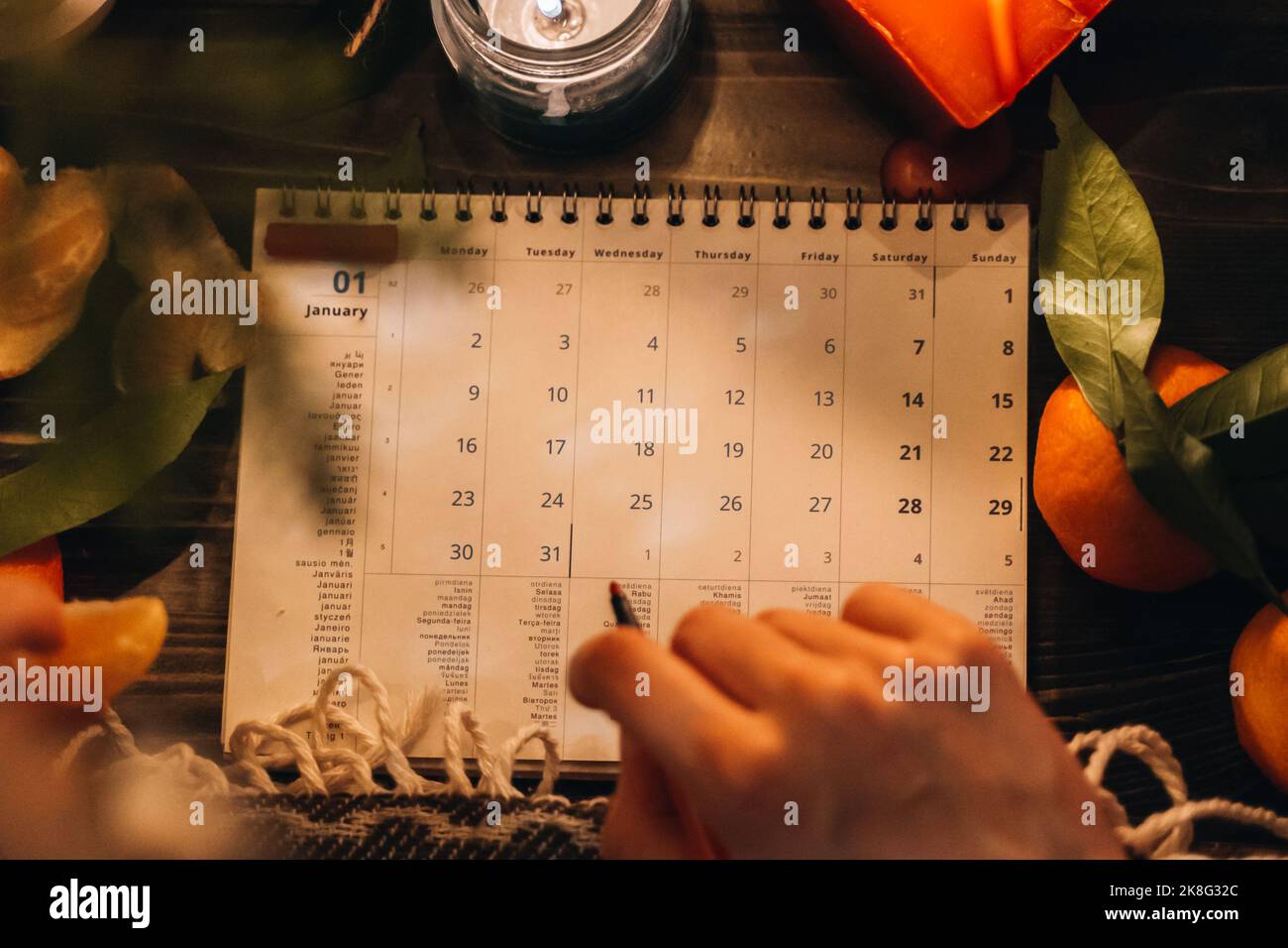 Planner page with Christmas sweets, mandarin oranges and candles ...