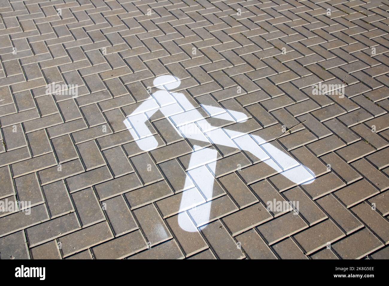 Road sign for pedestrians on paving slabs close up Stock Photo - Alamy