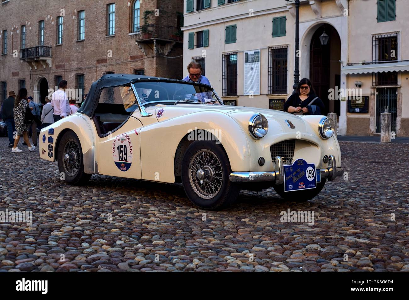 Historic car on a square surrounded by people Stock Photo - Alamy