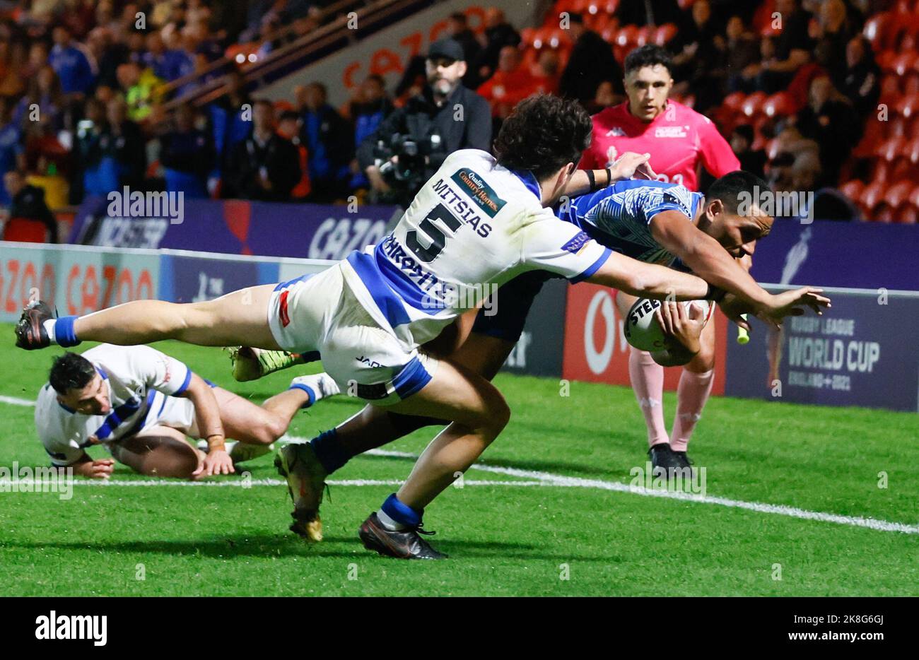Samoa's Matt Feagai is pushed into touch by Greece's Jonathan Mitsias ...