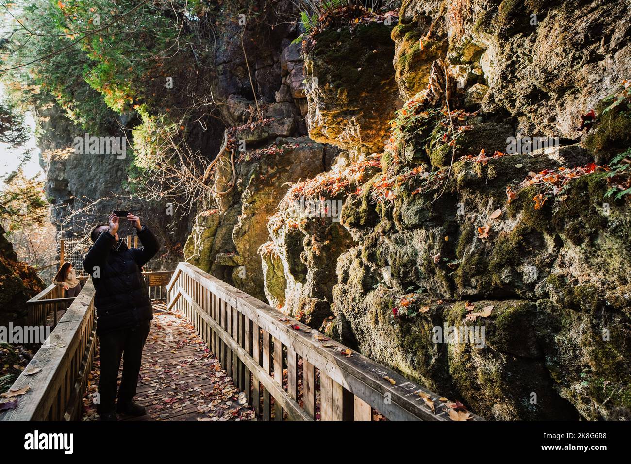 male visitor taking photo of rocks near pathway Stock Photo - Alamy