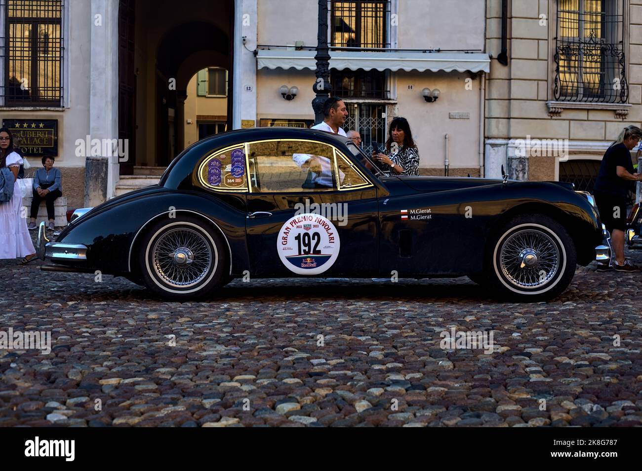 Historic car on a square surrounded by people Stock Photo - Alamy