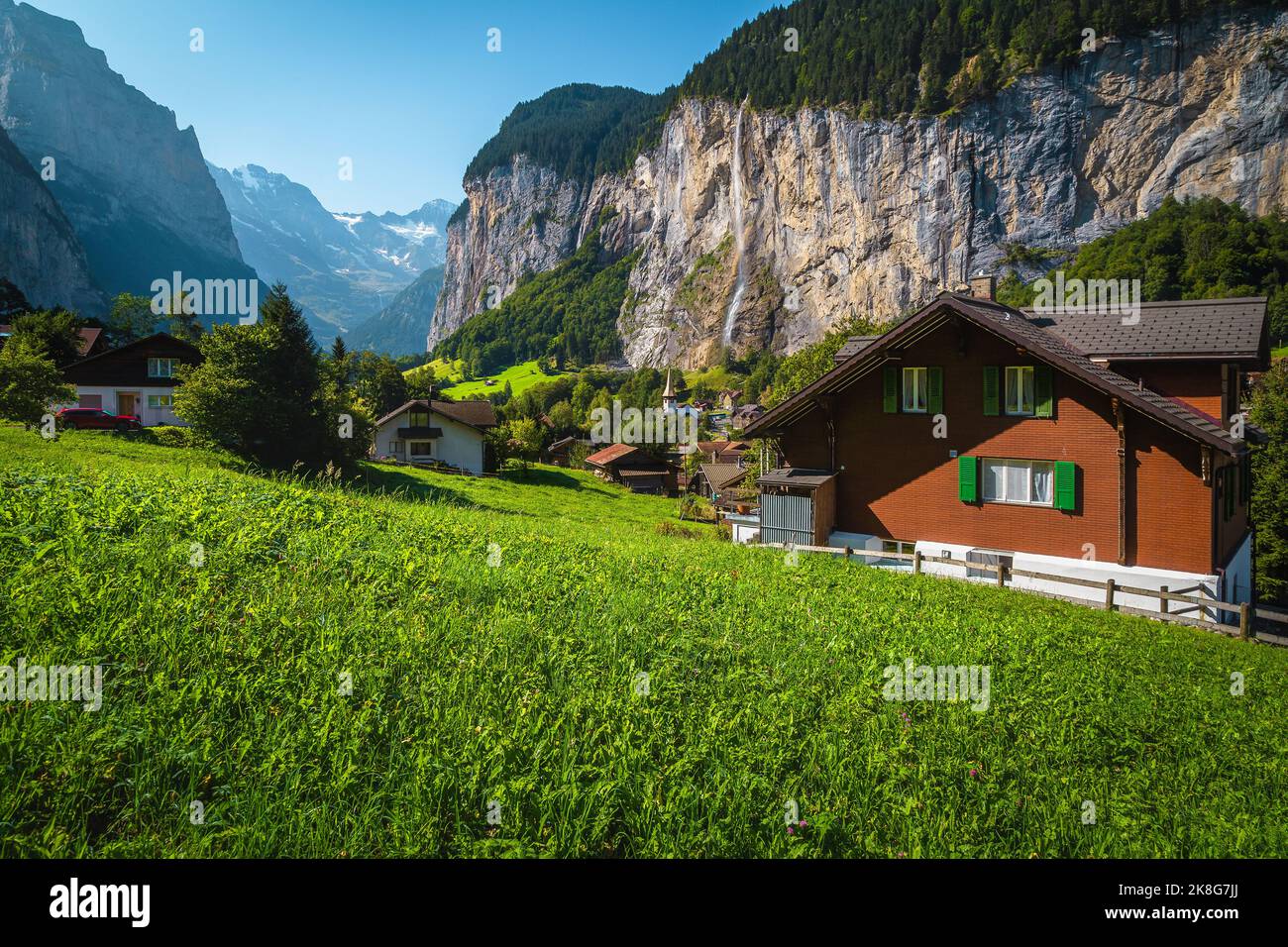 Majestic alpine places with green fields in the deep valley and ...