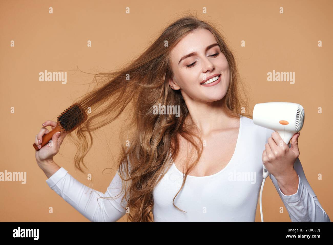 woman with strong healthy hair using hair dryer Stock Photo - Alamy