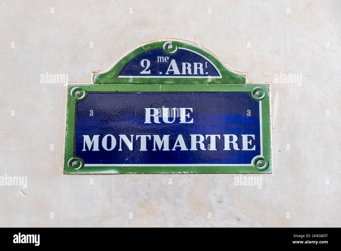 Traditional Parisian street sign with "Rue Montmartre" written on it ...