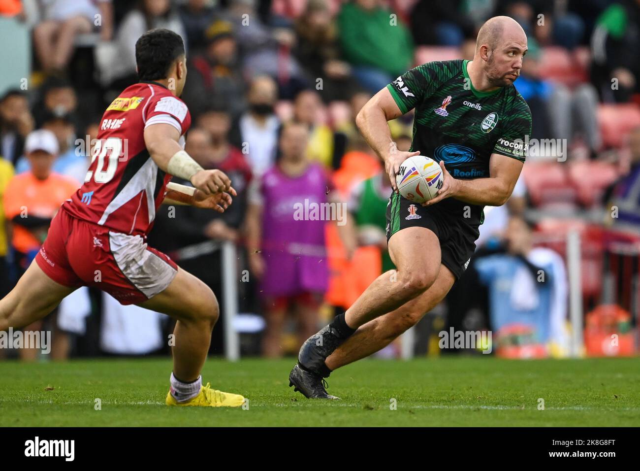 George King of Ireland makes a break during the Rugby League World Cup ...