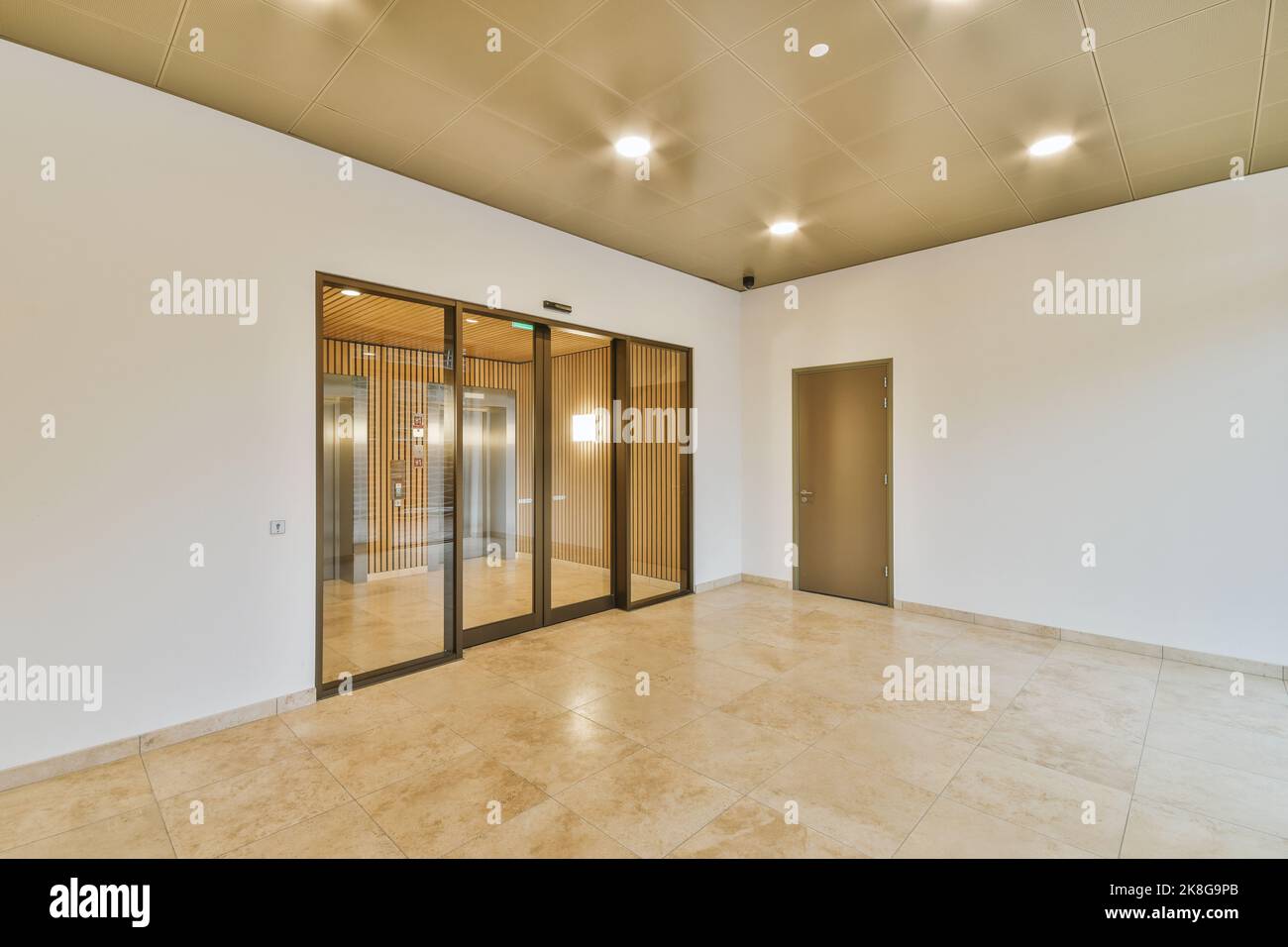 Stylish hallway with door and window to light elevator area in modern ...