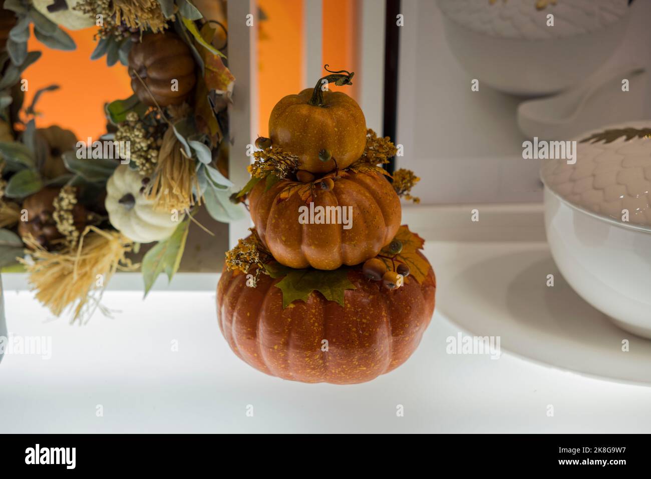 Close up view of cute pyramid of decorative pumpkins on white ...