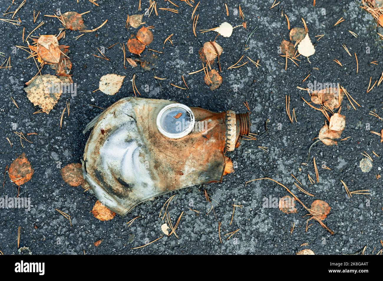 an old used gas mask lying on the damp grass on the ground Stock Photo ...