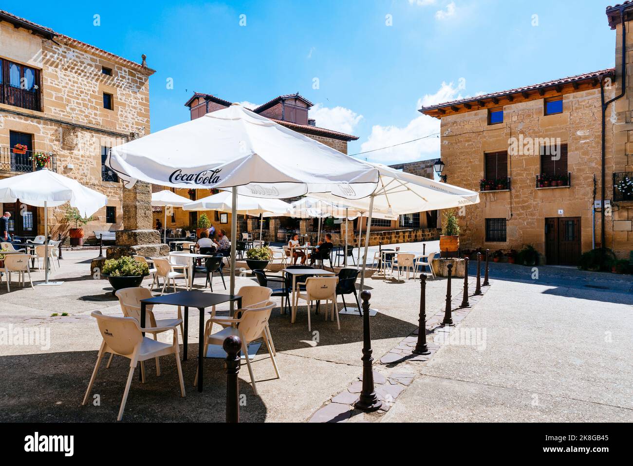 Sun umbrellas on the terrace of a bar in the town hall square. Street ...
