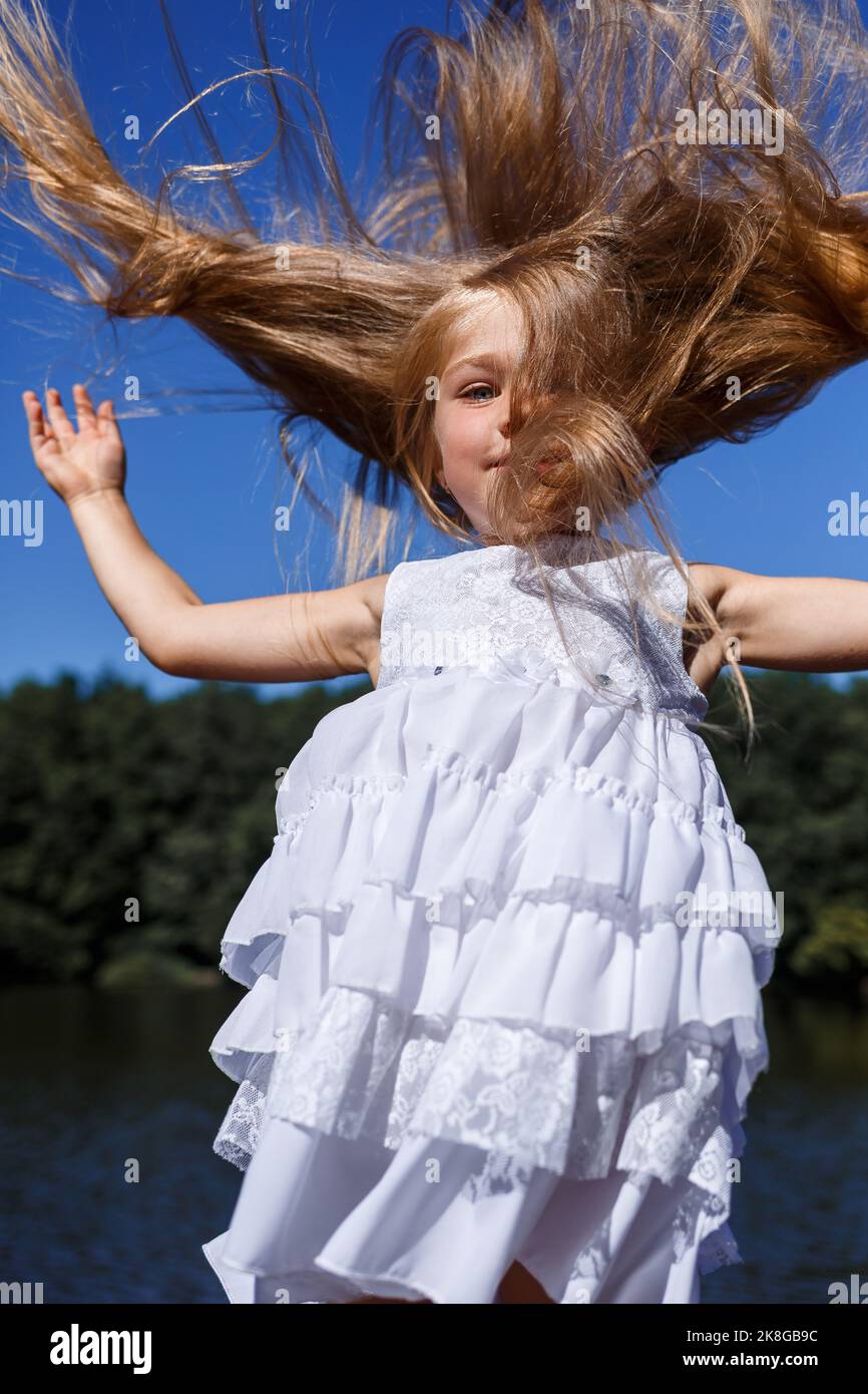 A Six Year Old Girl Is Wearing A White Dress Beautiful Long Hair Walk