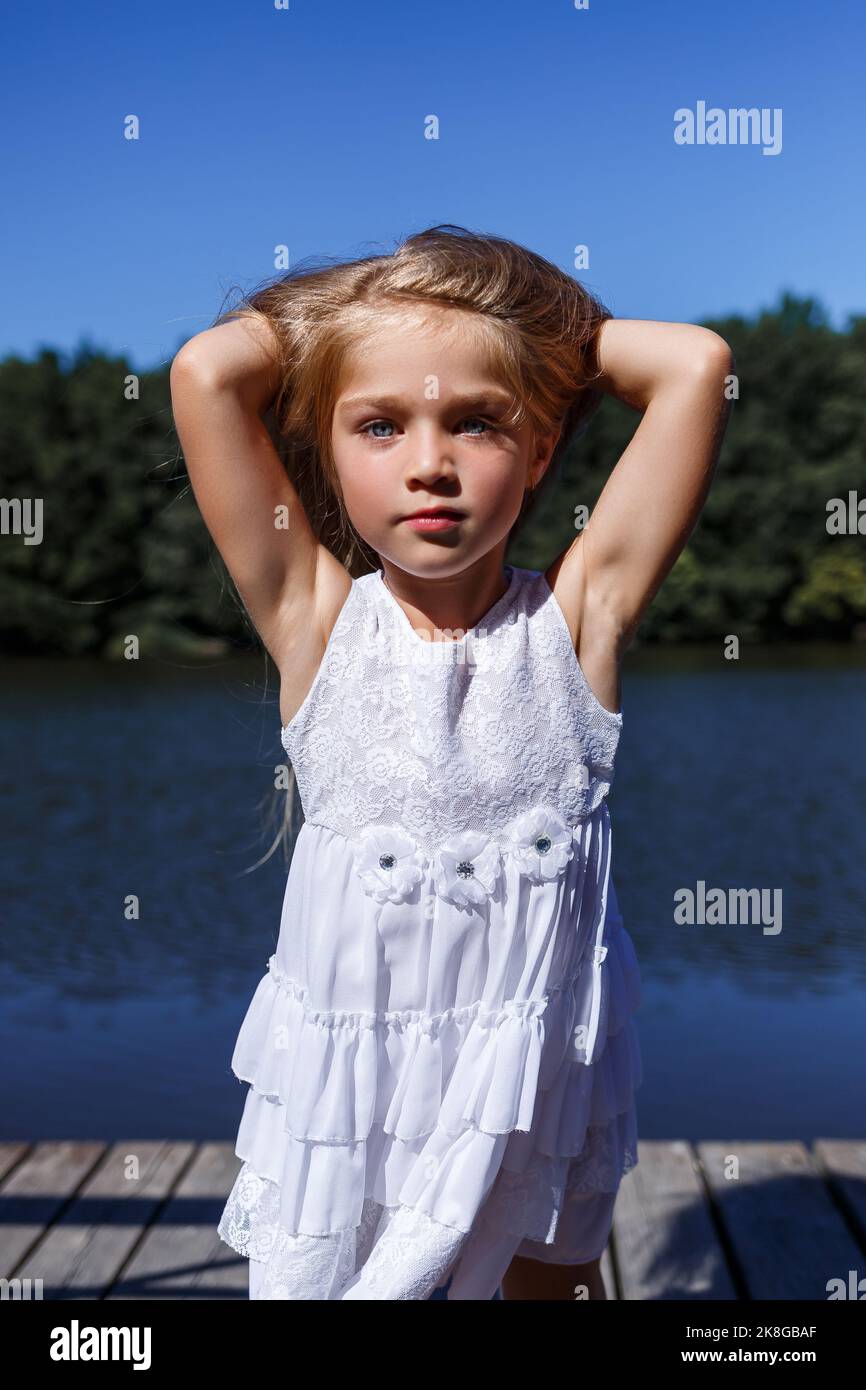 A Six Year Old Girl Is Wearing A White Dress Beautiful Long Hair Walk