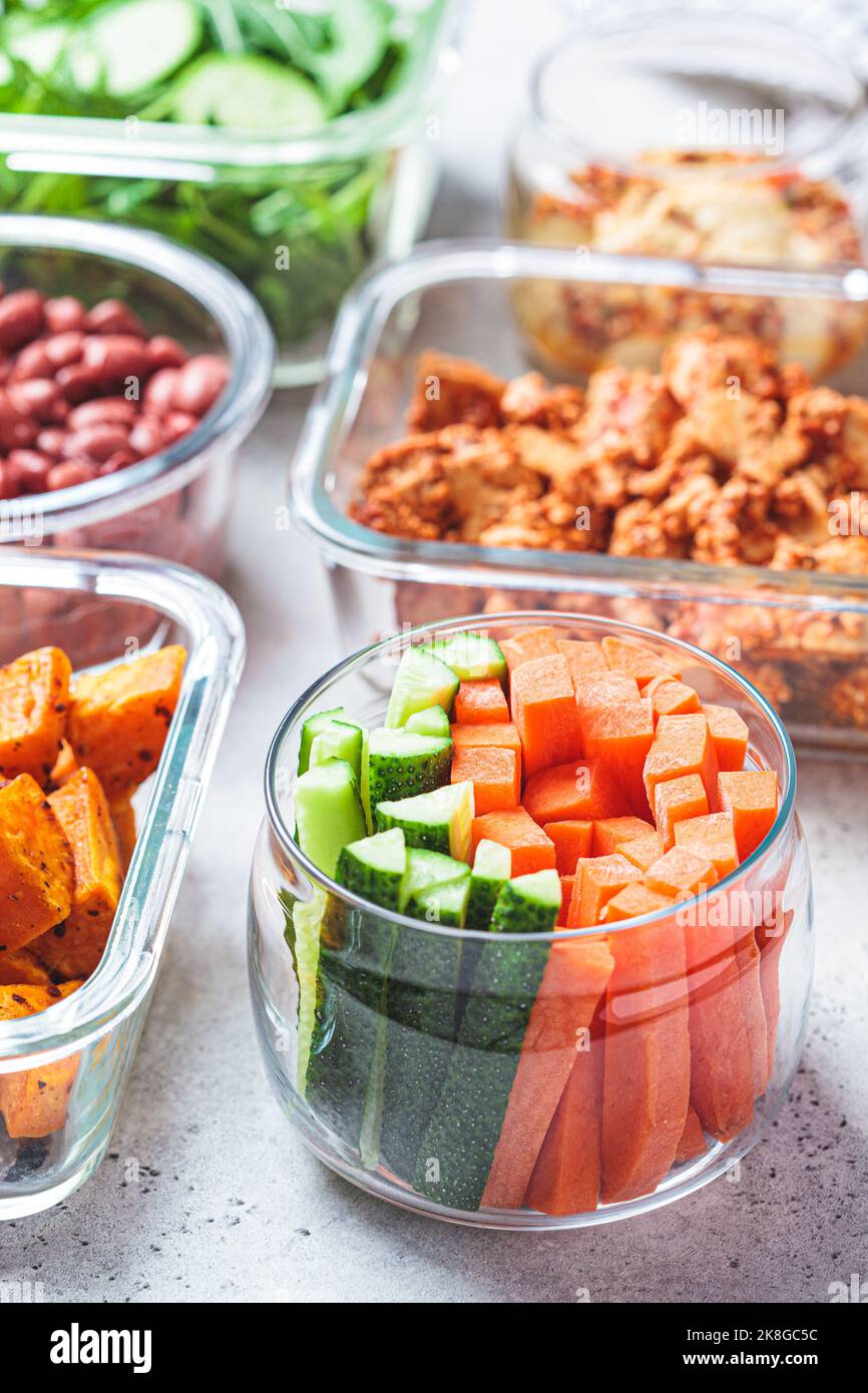 Vegan meal prep containers with cooked ingredients: marinated tofu ...