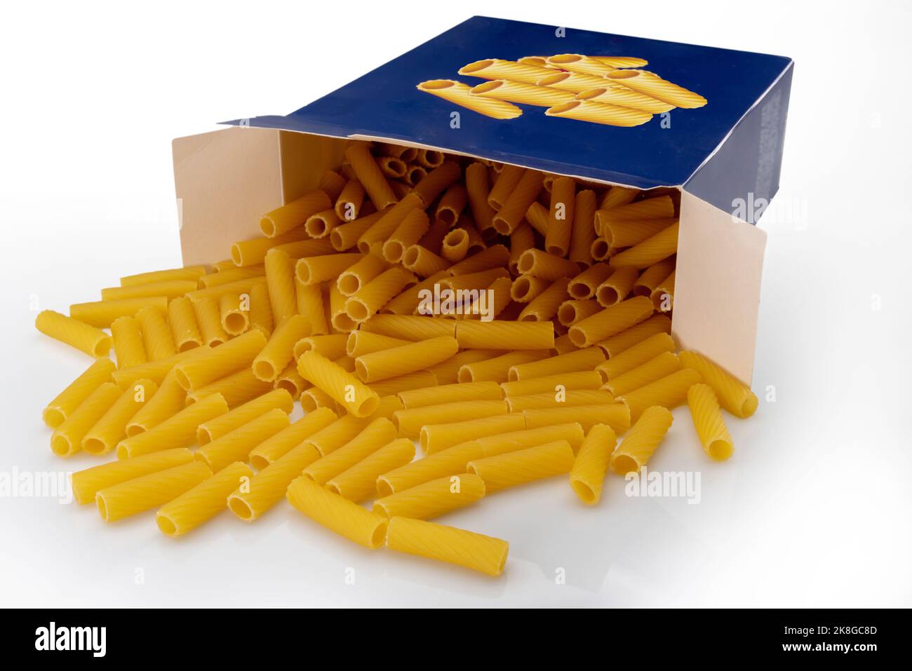 Macaroni tortiglioni pasta come out of blue package isolated on white ...