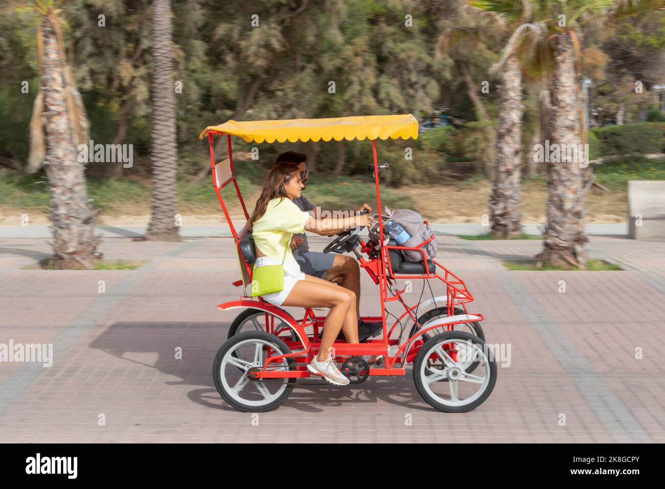 four wheeler surrey bike with tourist cycling along sea front by can ...
