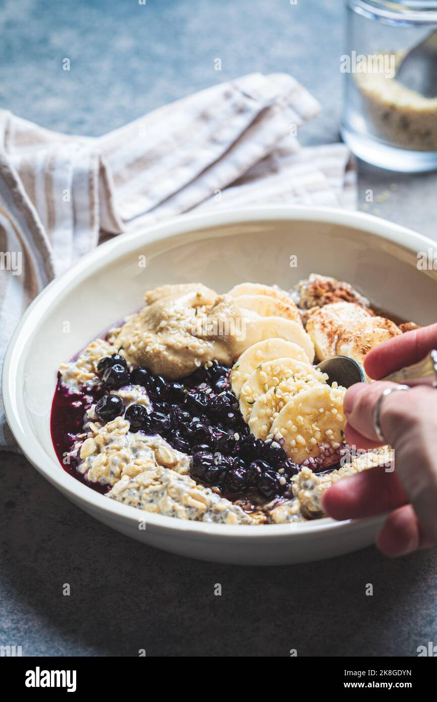 Winter breakfast concept. Overnight oatmeal with banana, berry, chia ...