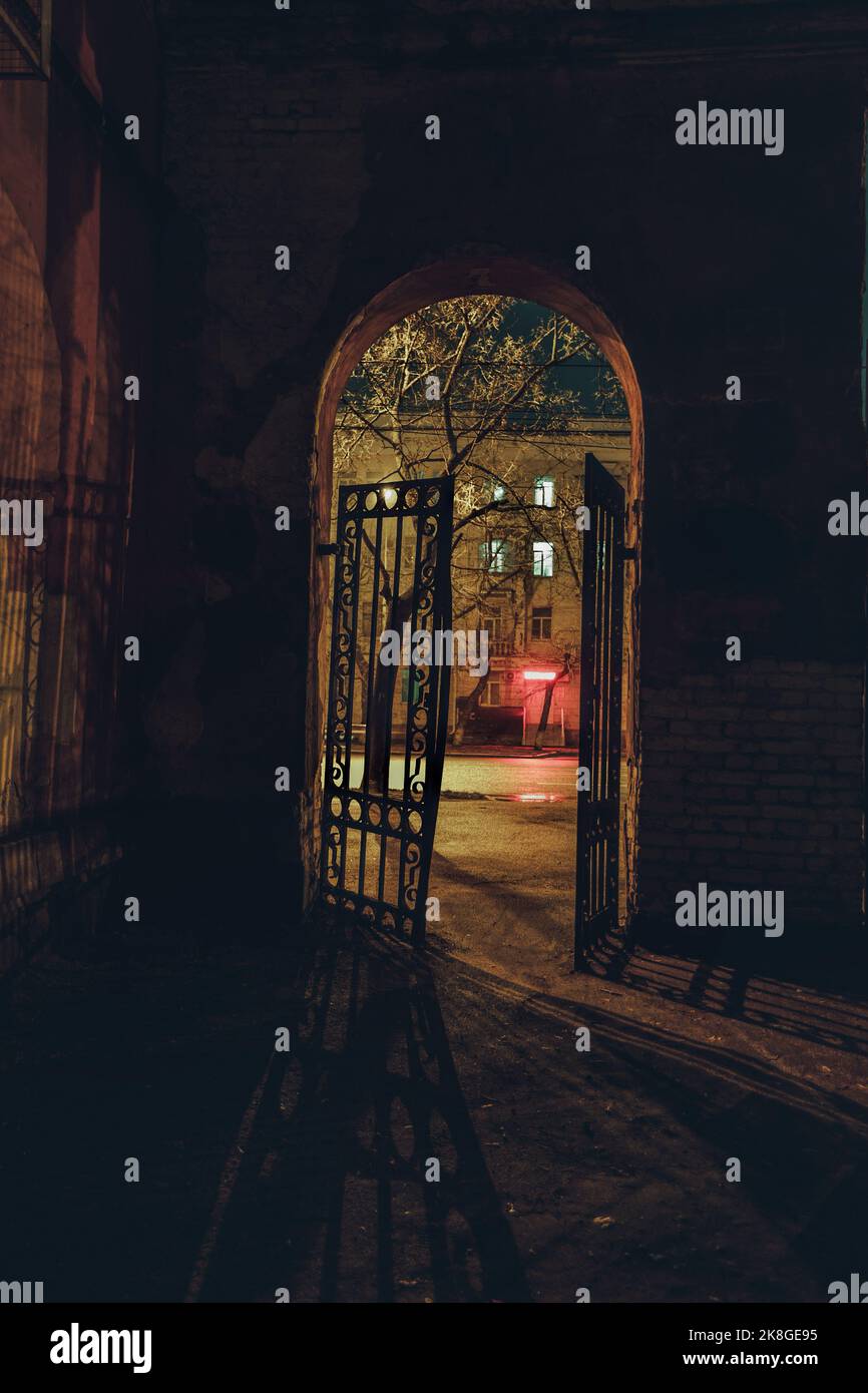 Old gate with a lattice in night city Stock Photo - Alamy