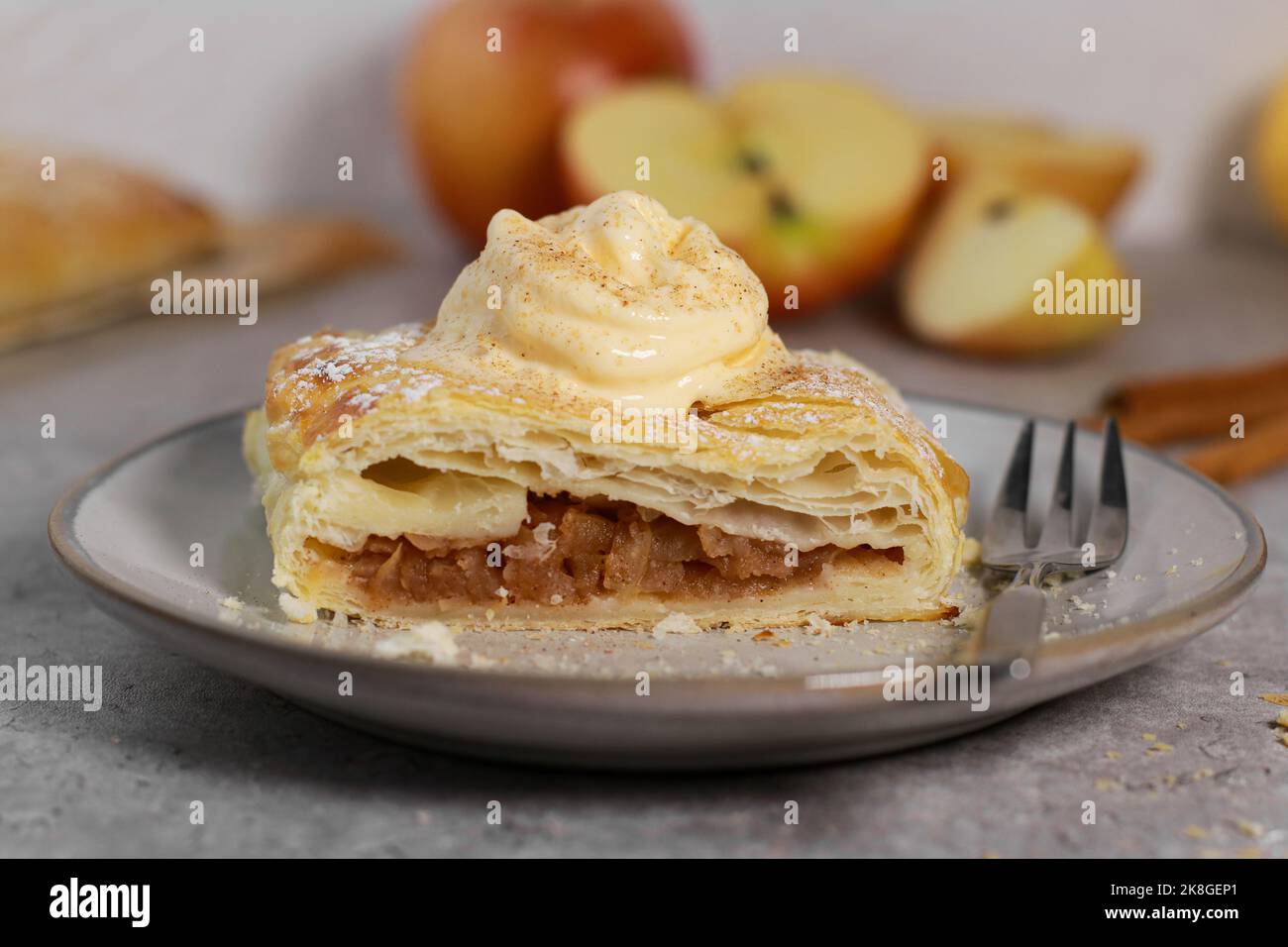 piece of an apple strudel roll with cinnamon and ice cream on top Stock ...