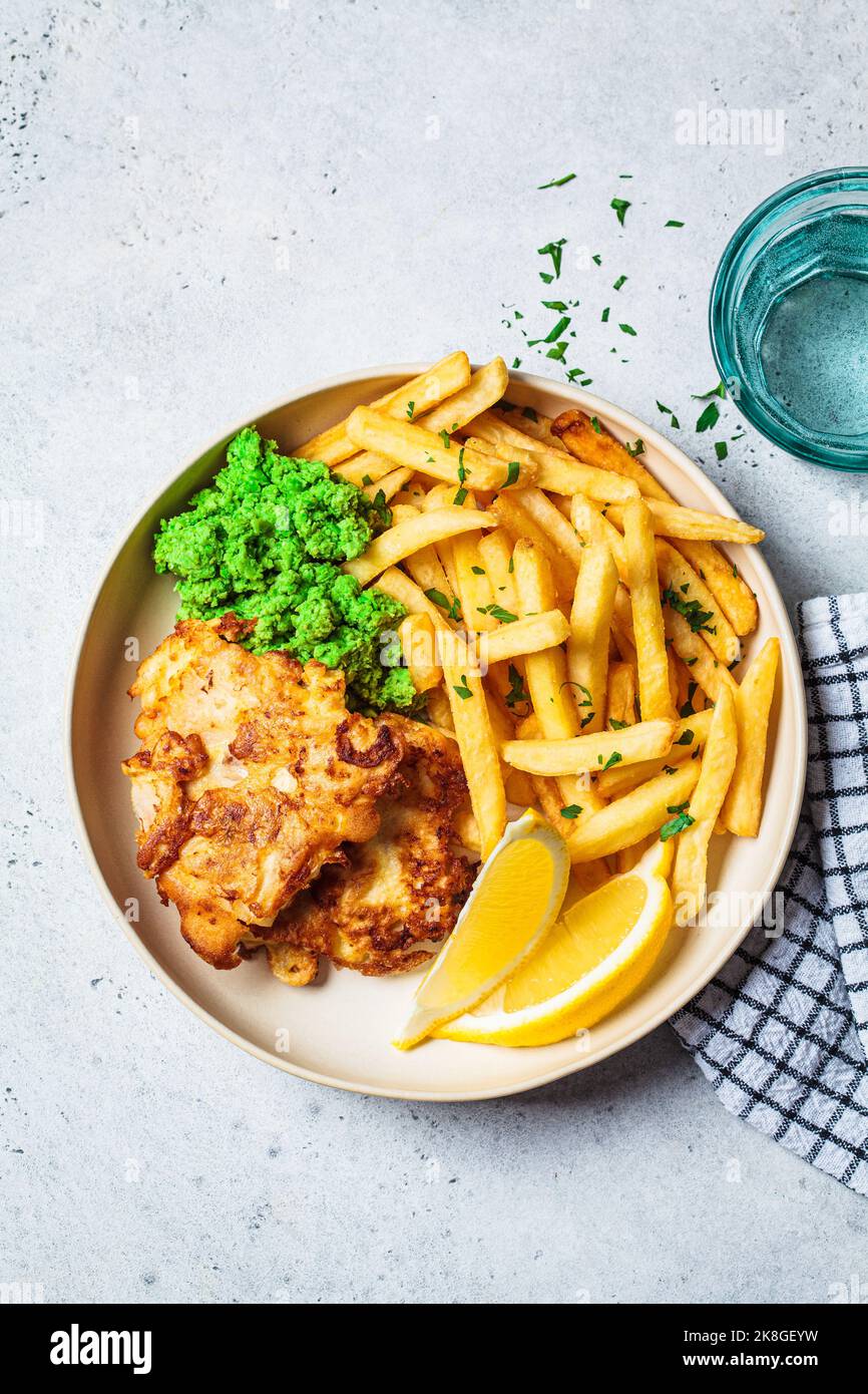 Fish and chips. Cod fish in batter with french fries and mashed green ...