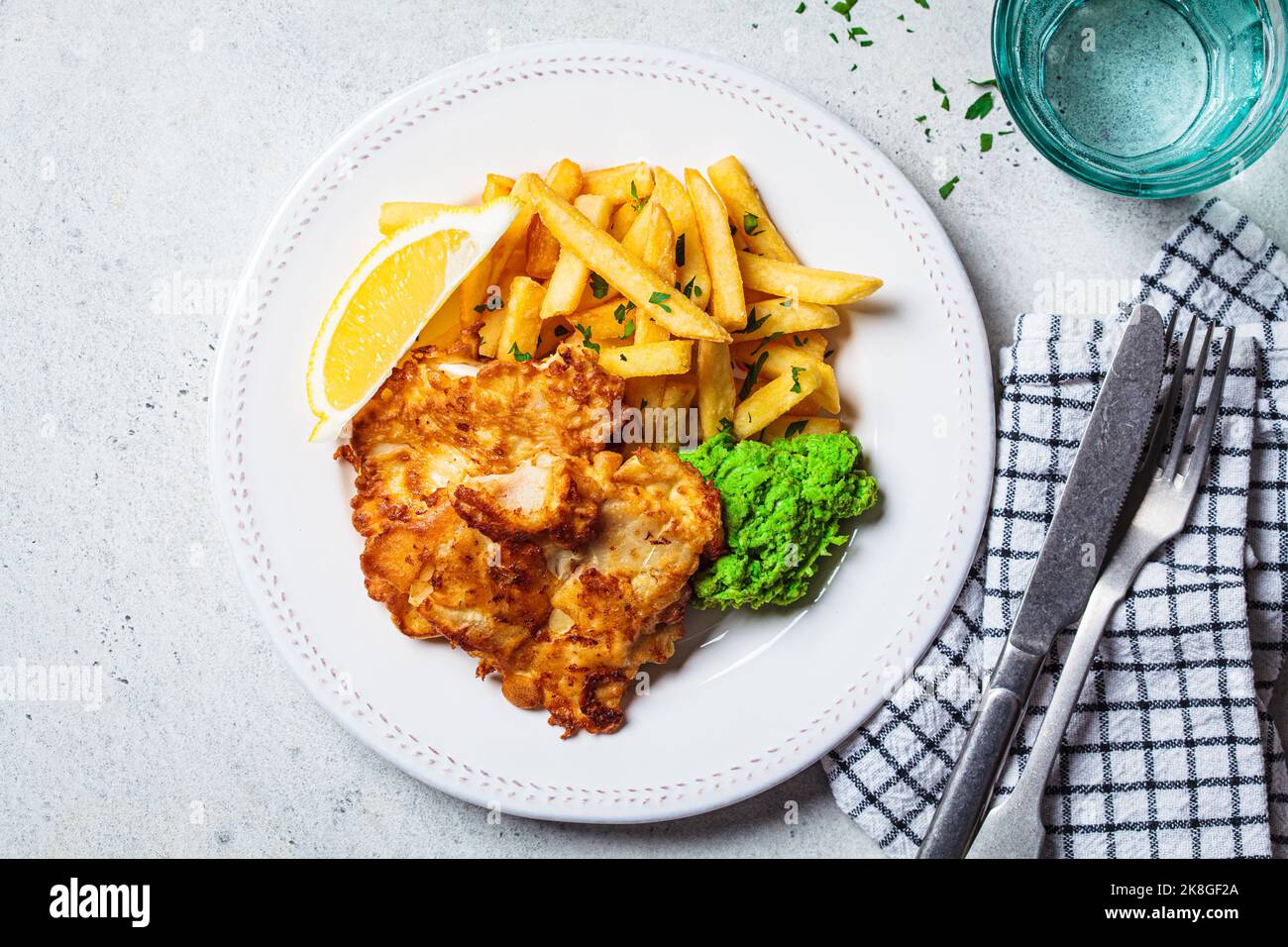Fish and chips. Cod fish in batter with french fries and mashed green ...