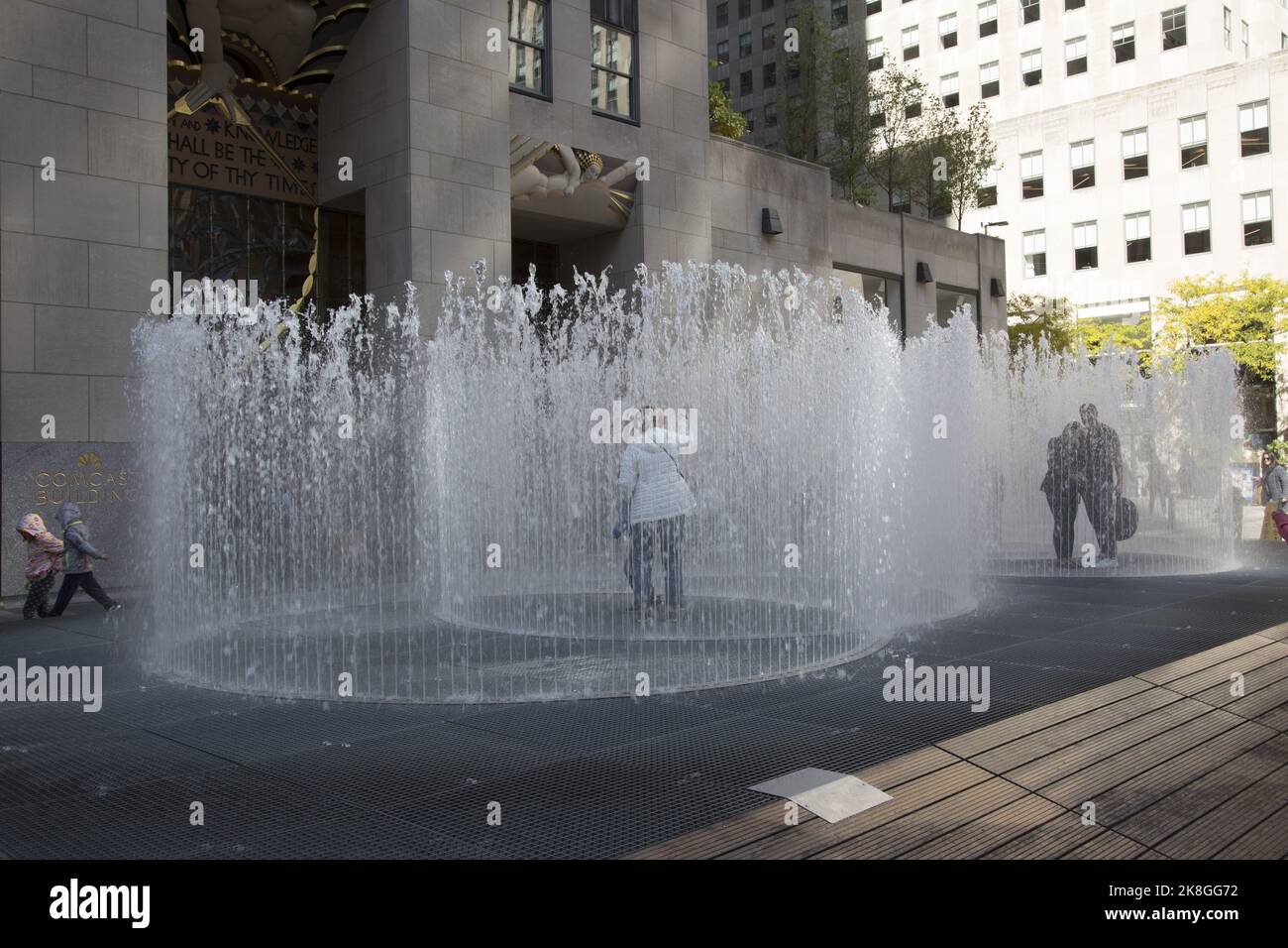 People have fun at an interactive fountain on the plaza at Rockefeller ...
