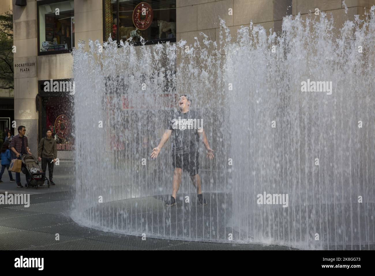 Boy has fun at an interactive fountain on the plaza at Rockefeller ...