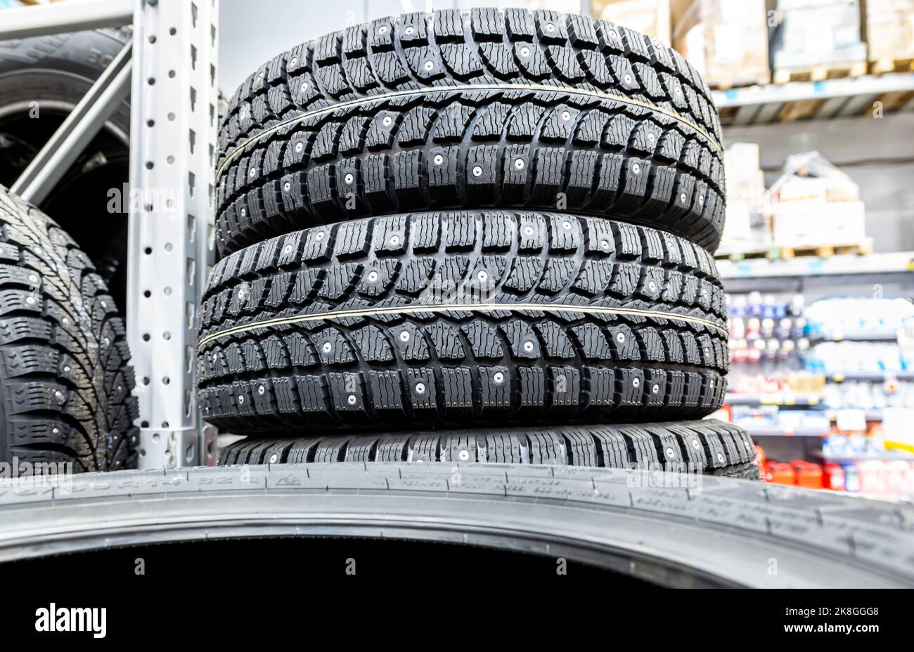 Winter vehicle tires stacked up for sale in the superstore. New studded ...