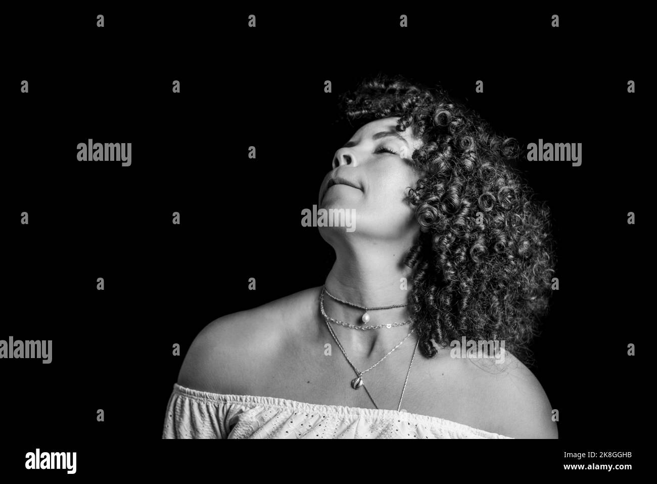 Black and white portrait of beautiful woman against black background ...
