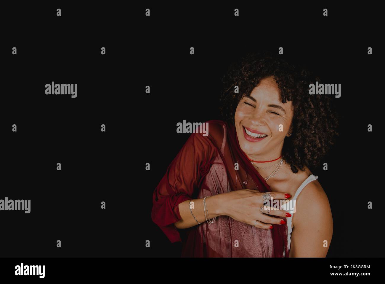 Smiling beautiful woman with red cloth wrapped around her body against ...