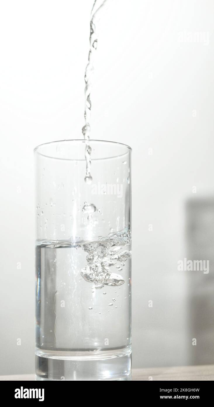 Pour water in glass isolated on white background with clipping path ...