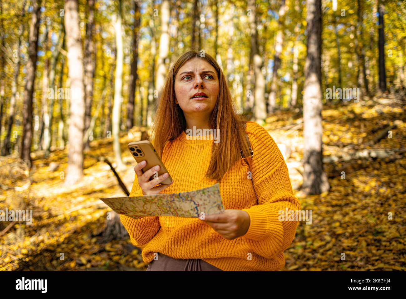 Lost traveler young woman searching direction on background of map with ...