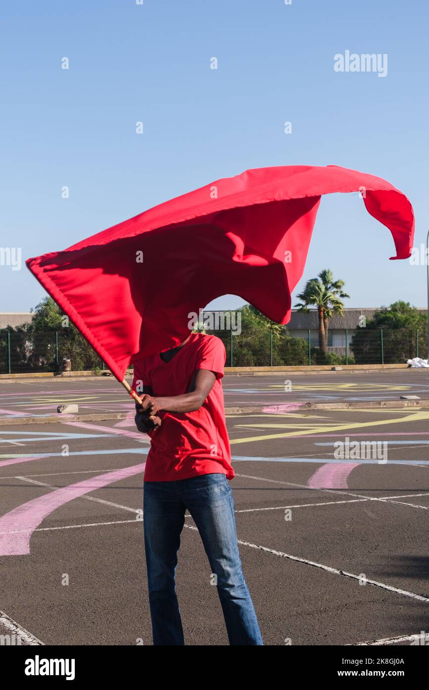 Unknown man waving the flag of his team as support in the competition ...