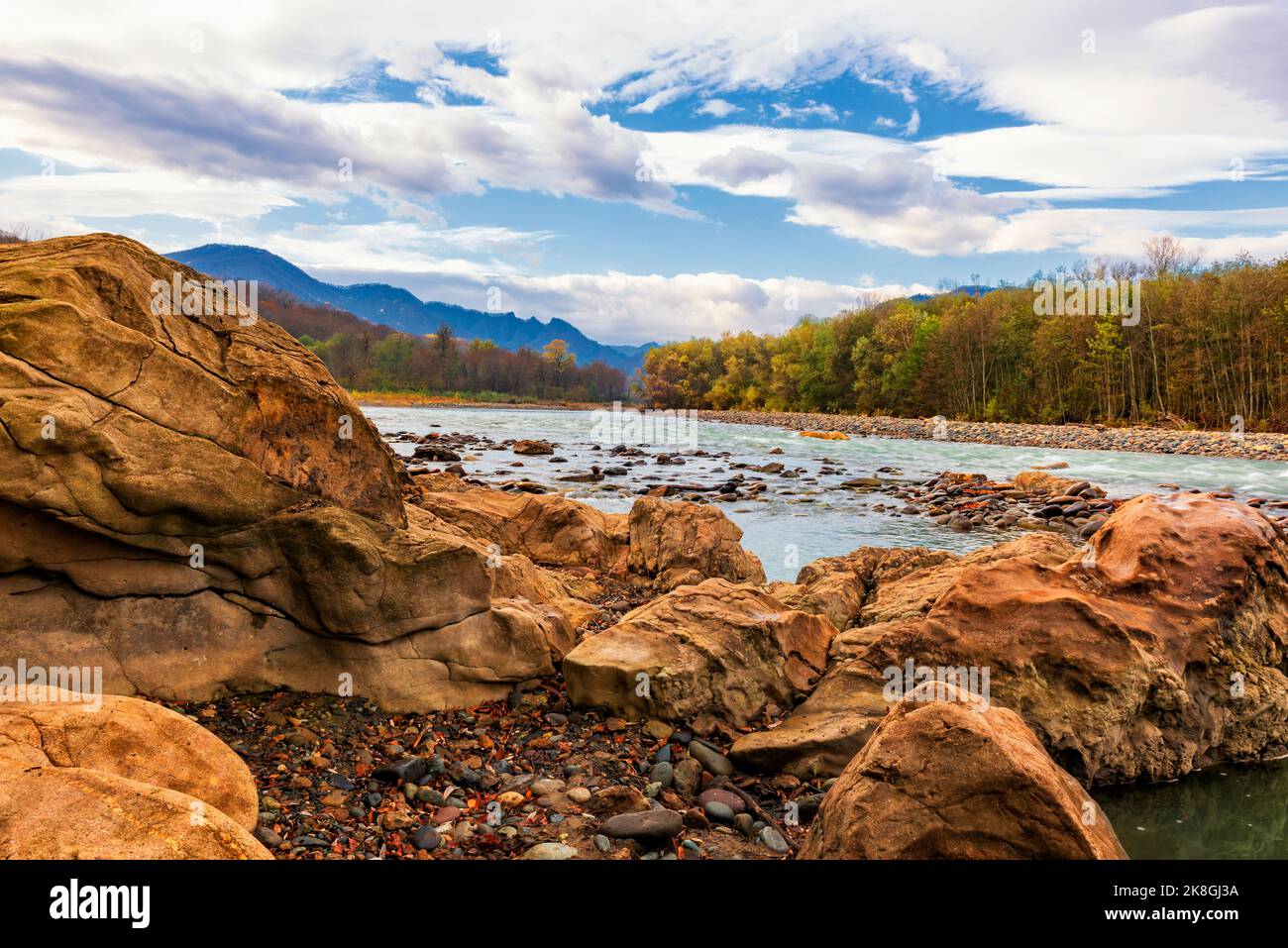 Landscape of a river with a fast current flowing in the foothills Stock ...