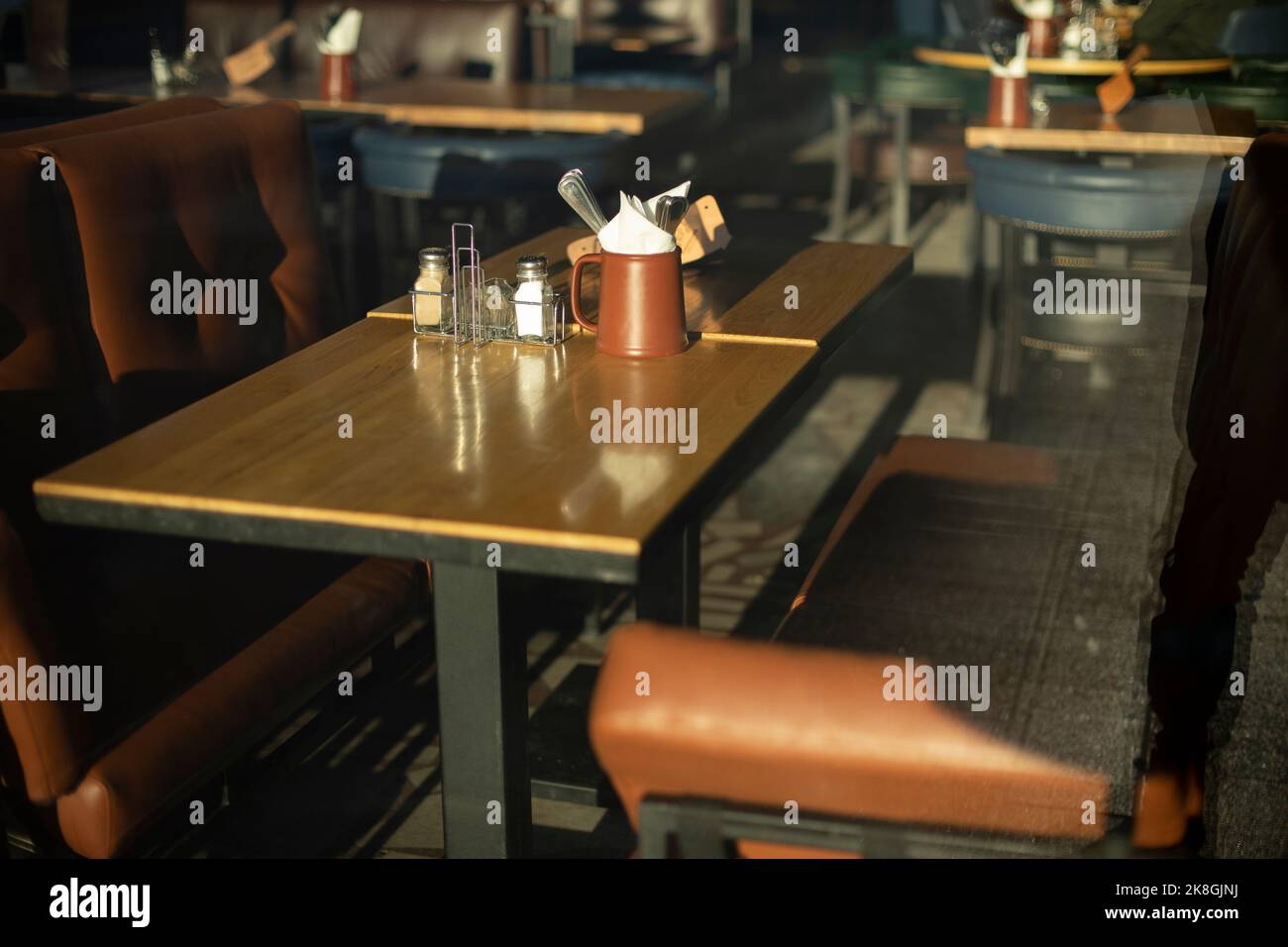 Table in restaurant. Place to relax. Brown sofa. Dining table. Empty ...