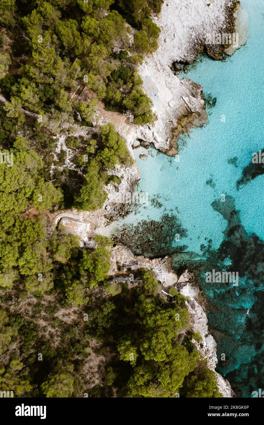 From above spectacular view of cala mitjana rocky green coast in ...