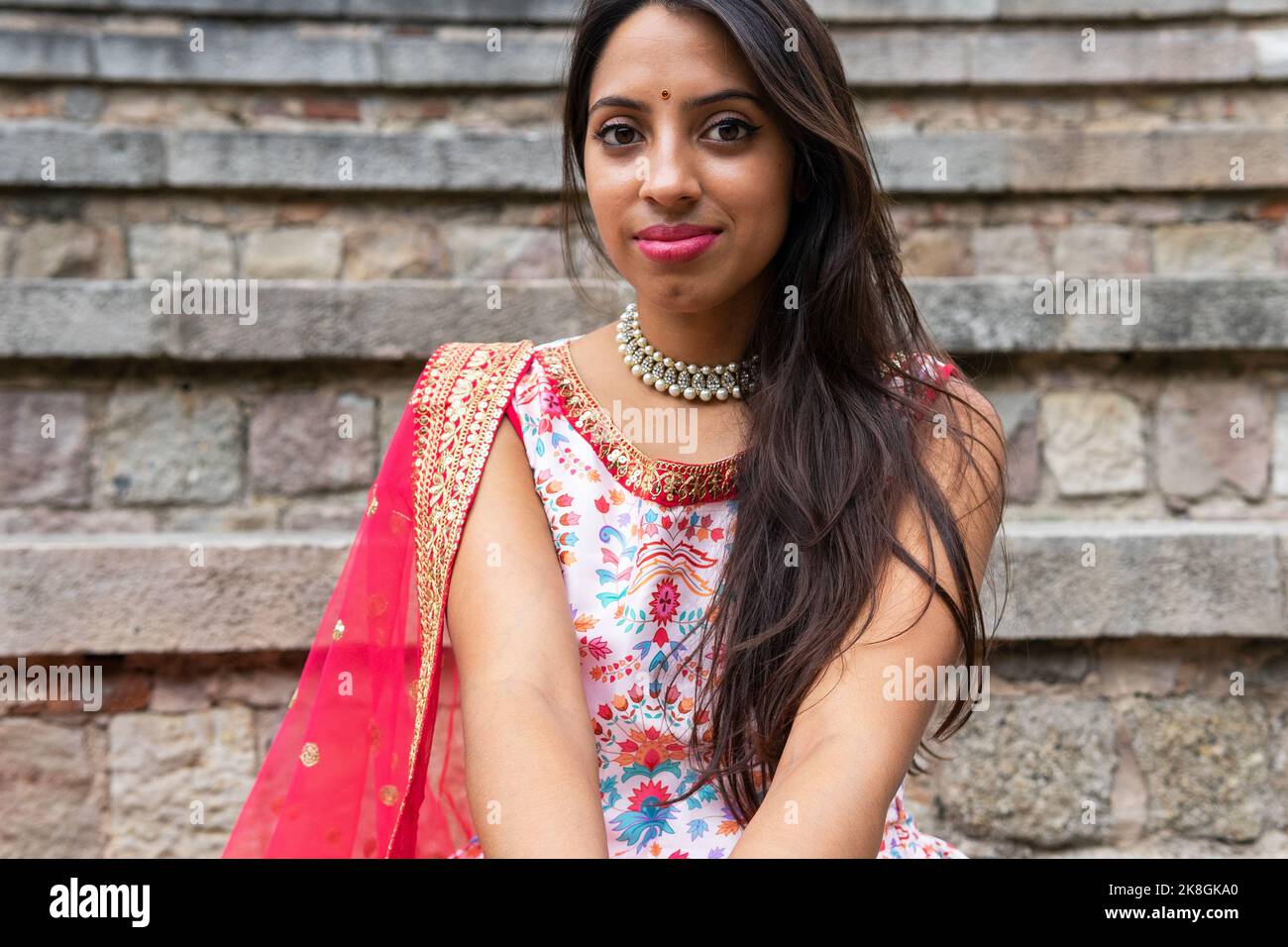 Side view of happy young Indian female in traditional sari outfit ...