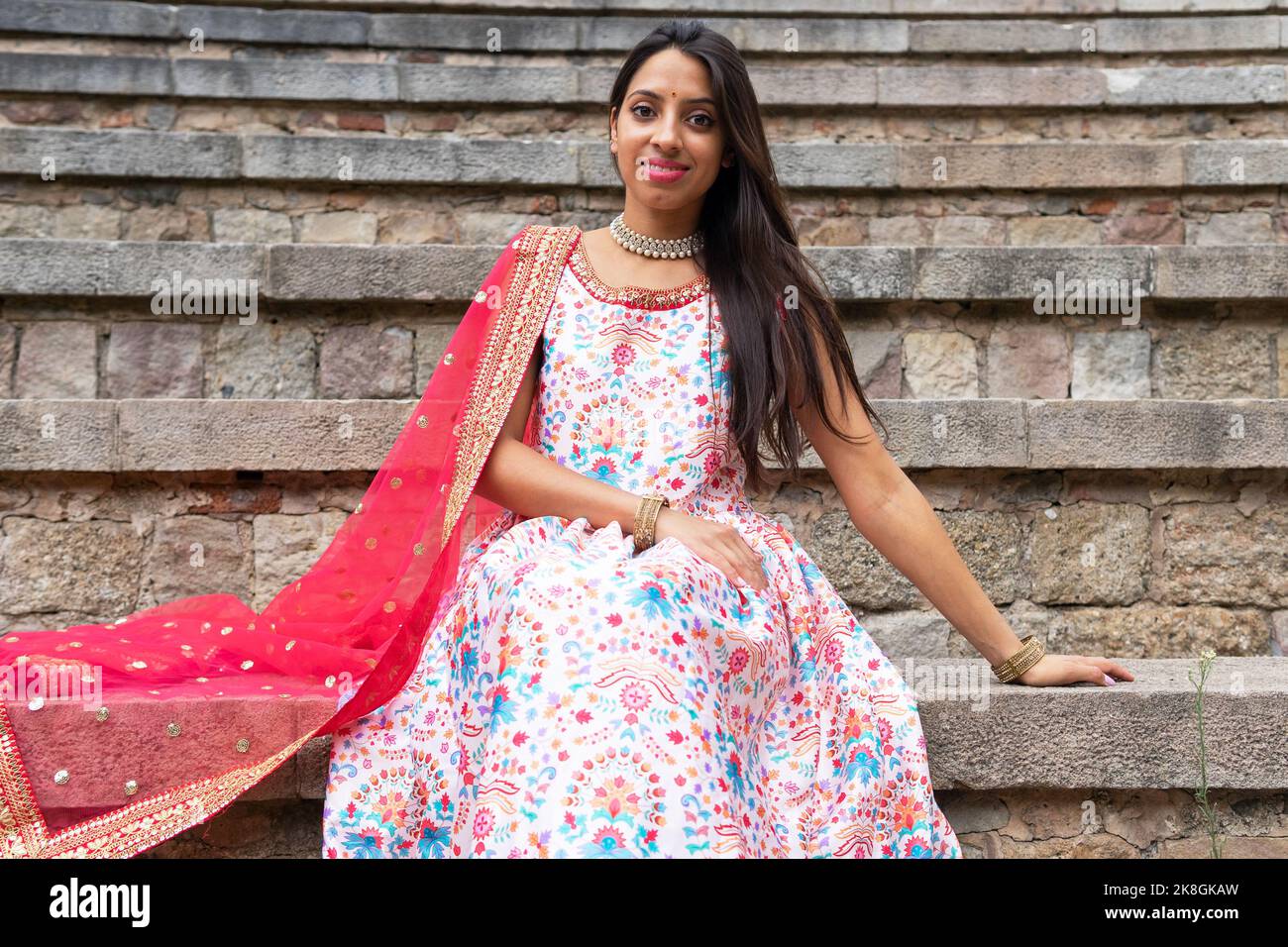 Side view of happy young Indian female in traditional sari outfit ...