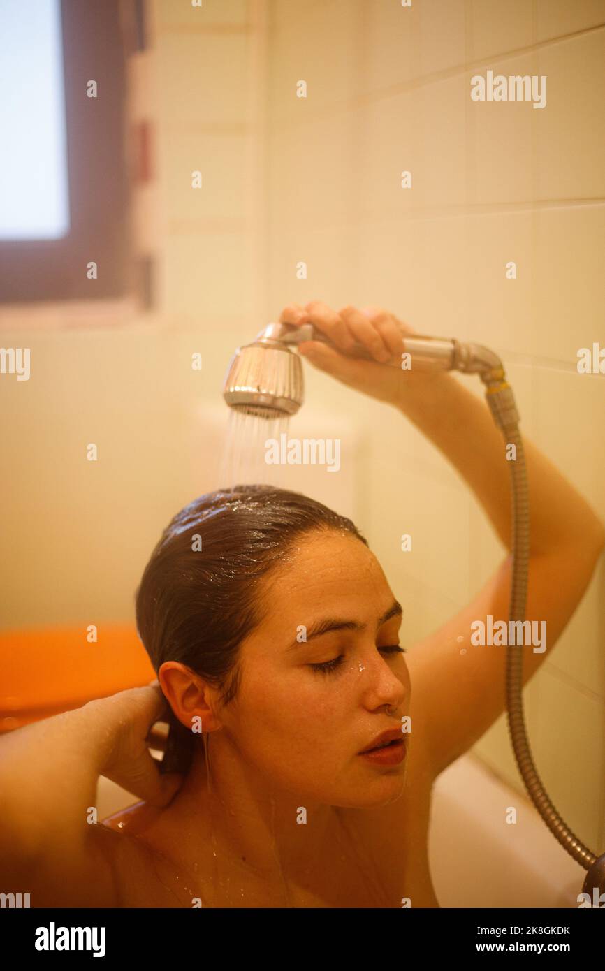 Attractive Woman With Closed Eyes Holding Shower Head And Pouring Water