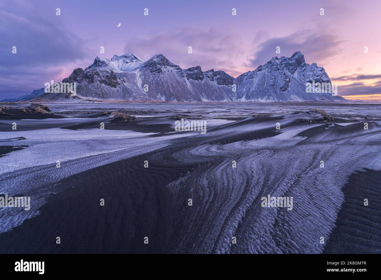 Spectacular Nordic scenery of calm frozen lake near rocky Vestrahorn ...