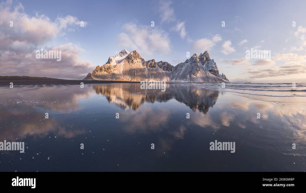 Spectacular Nordic scenery of calm frozen lake near rocky Vestrahorn ...