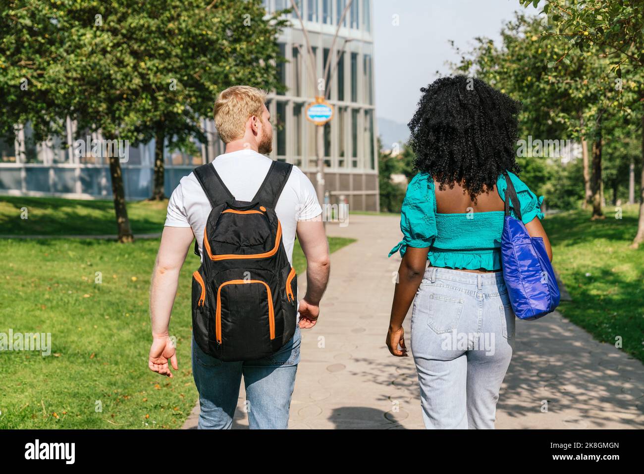 Back view of anonymous multiracial male and female tourists with ...